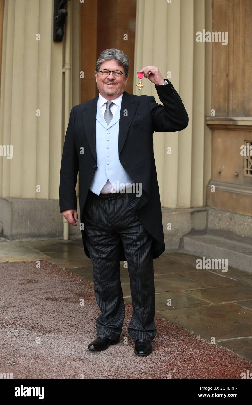 Consultant plastic surgeon Professor Simon Kay holds his OBE following ...