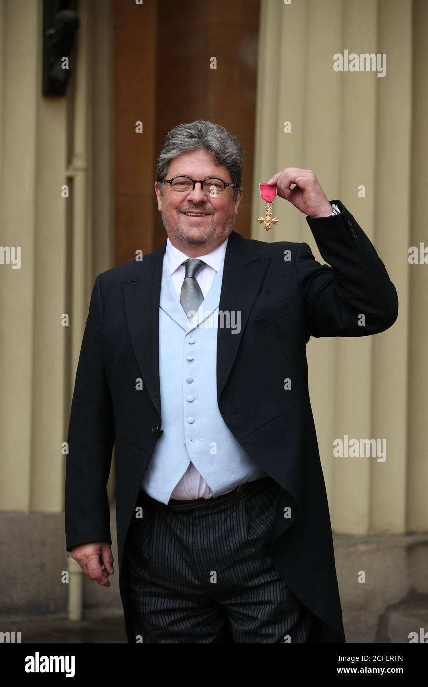 Consultant plastic surgeon Professor Simon Kay holds his OBE following ...