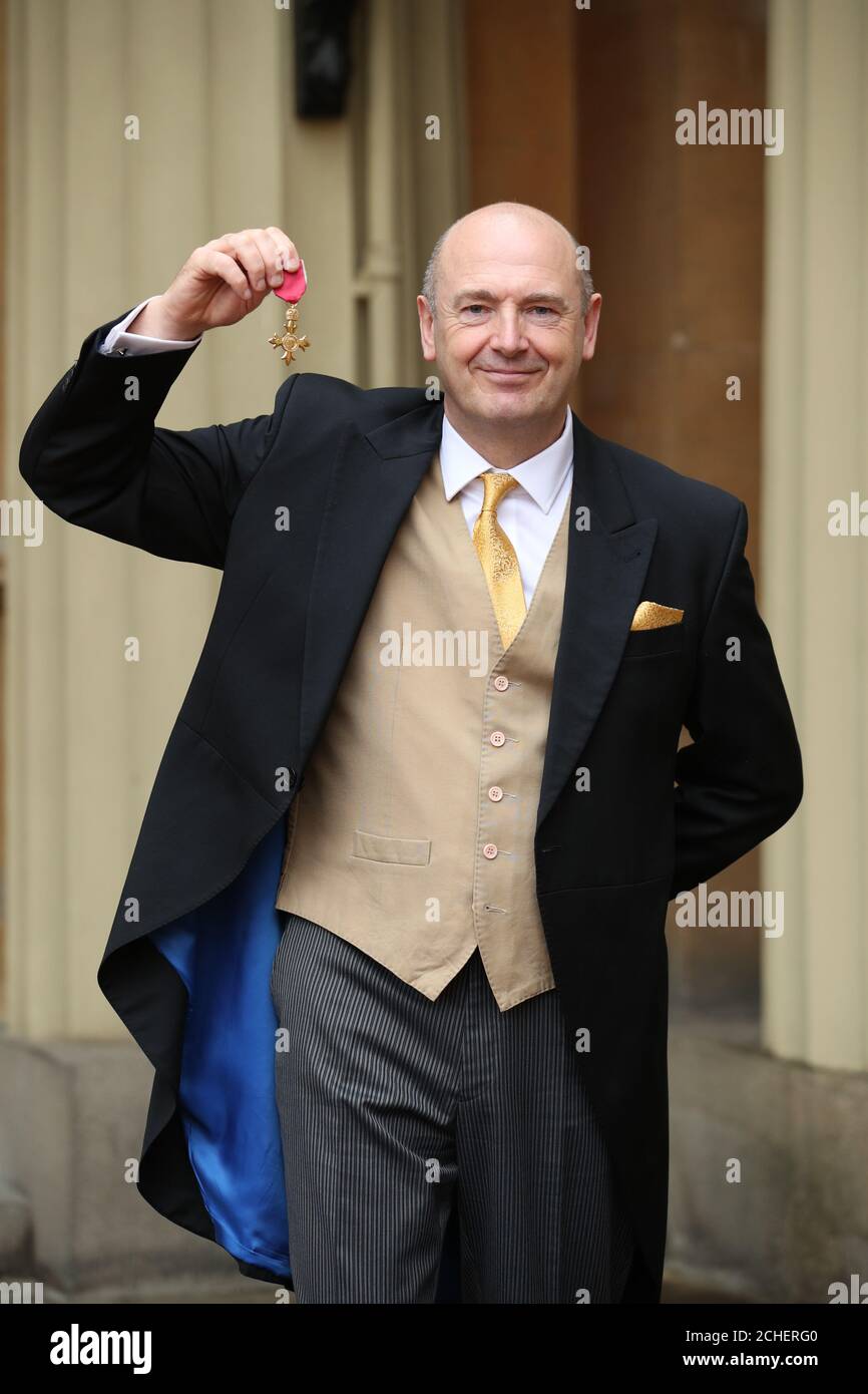 Jonathan Hart holds his OBE for services to Mountain Rescue in Scotland ...