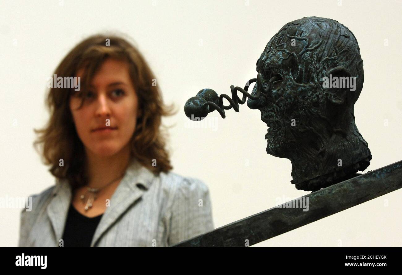 Tate press officer Louise Butler looks at a detail from 'When Humans ...