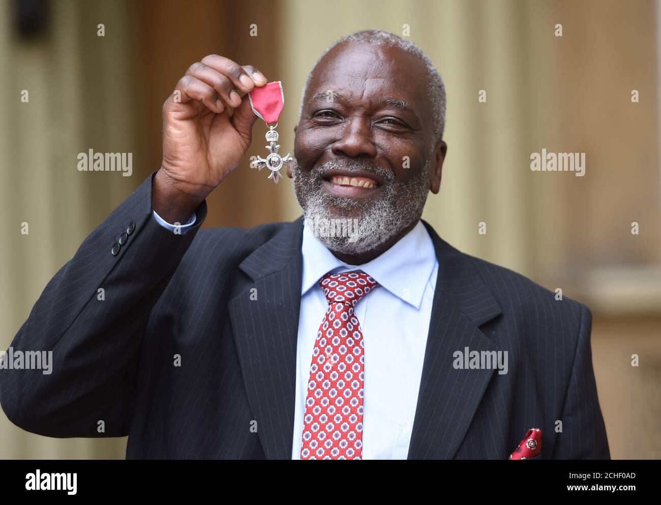 Joshua Johnson with his MBE following an investiture ceremony at ...