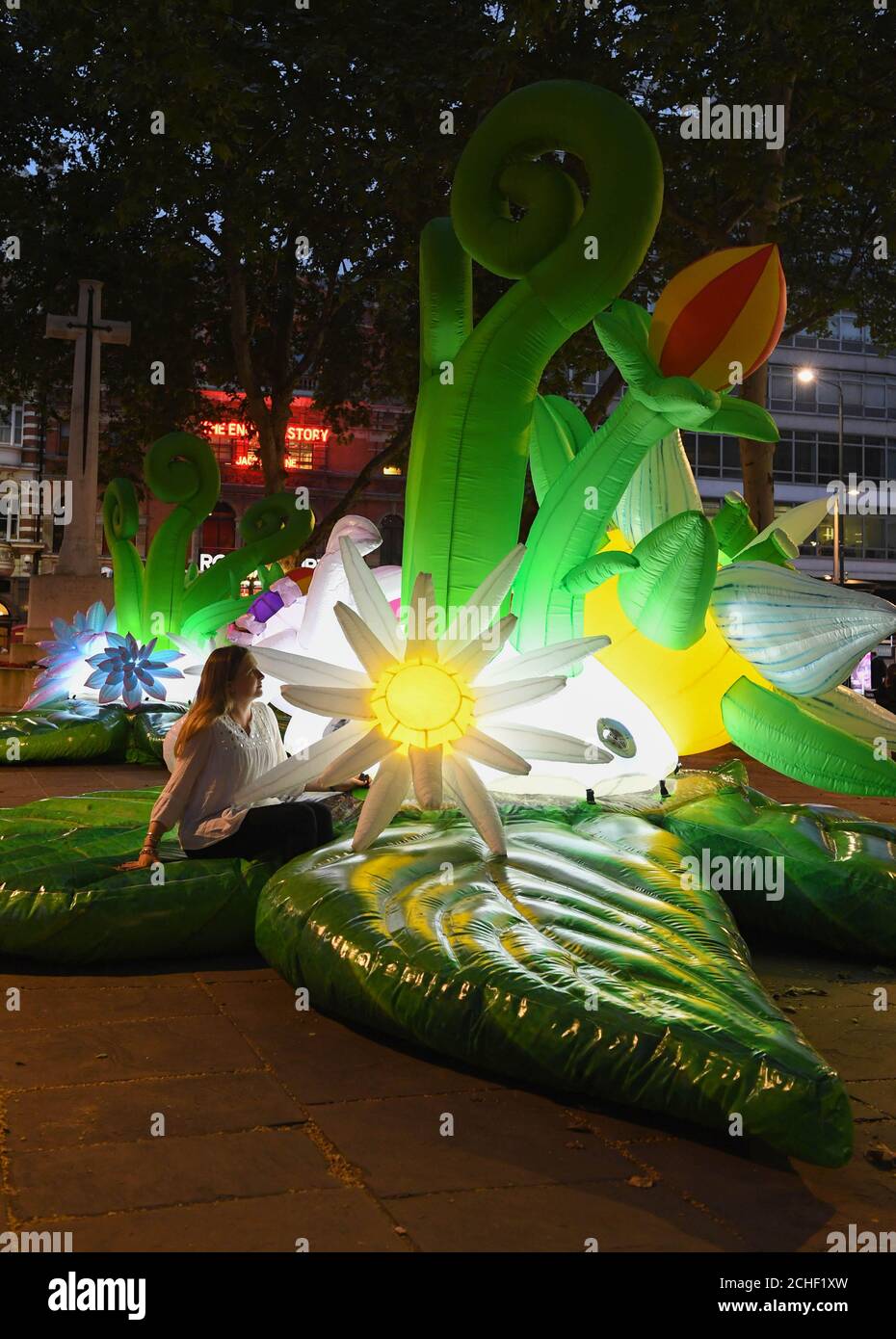 Members of the public look at a large-scale luminous installation 'LOST ...
