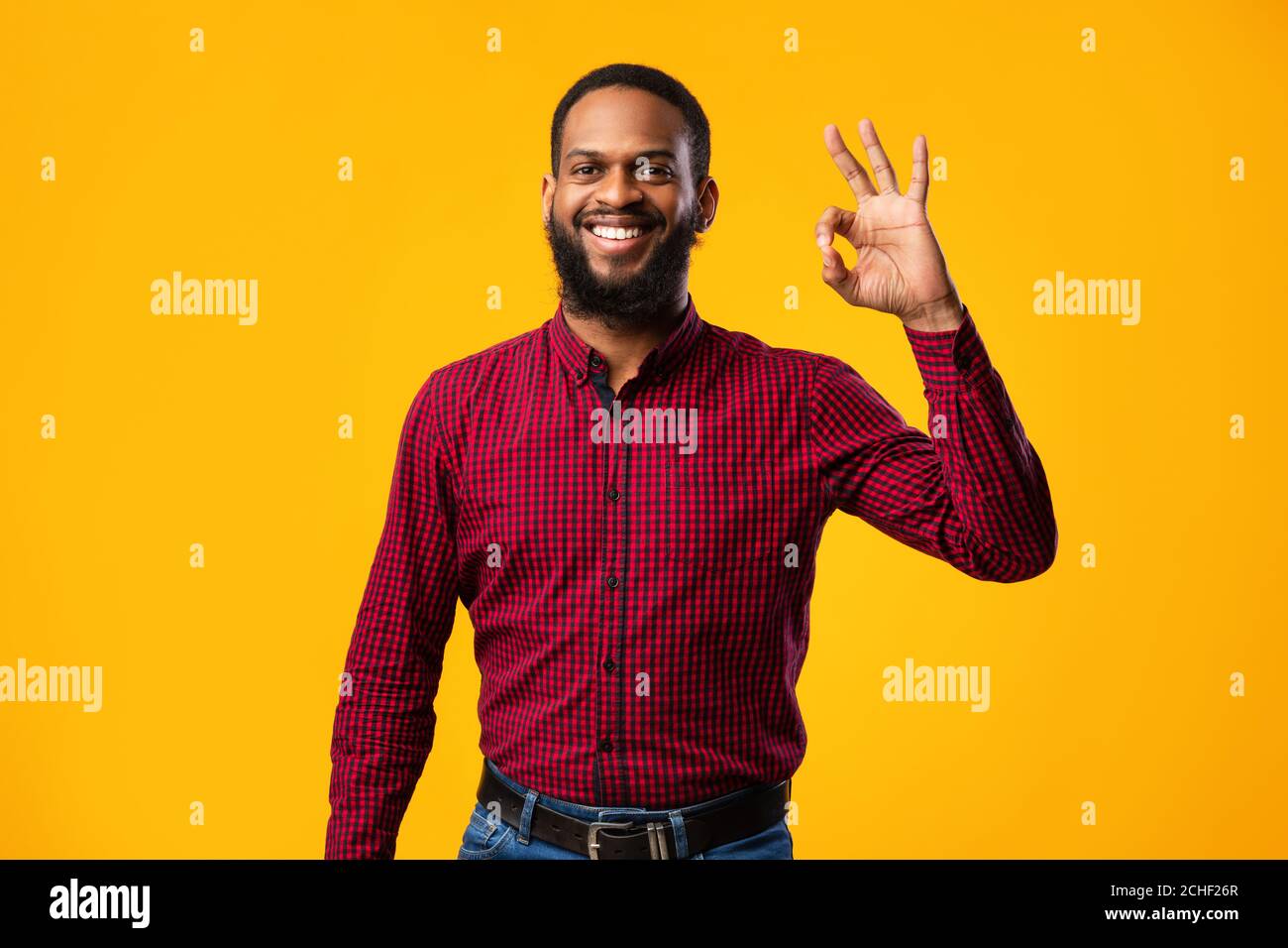 Happy black guy gesturing ok sign and smiling Stock Photo - Alamy