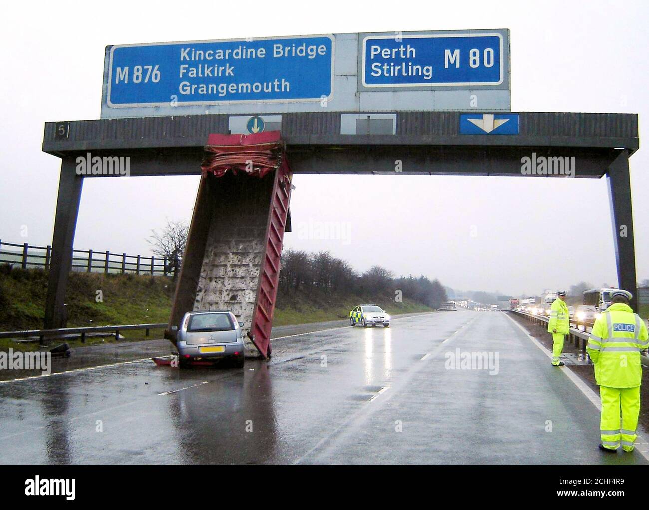 A tipper truck wedged underneath a motorway sign after a freak accident ...