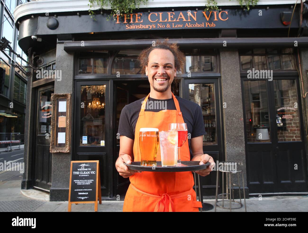 EDITORIAL USE ONLY Bartender Kieran Jay Johnson serves drinks to ...