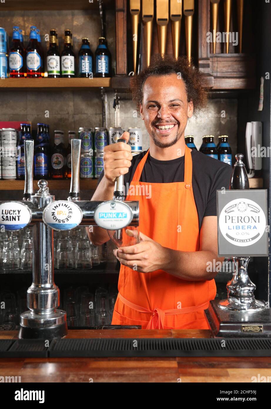 Bartender Kieran Jay Johnson serves drinks to customers at the 'The ...
