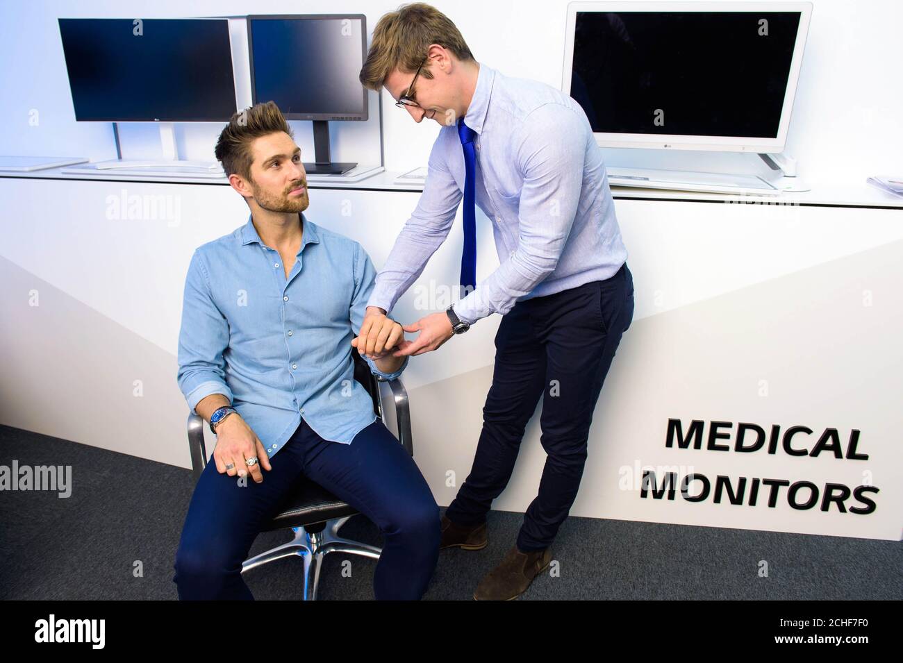 EDITORIAL USE ONLY Identical twin Henry Wade is fitted with a monitor ...