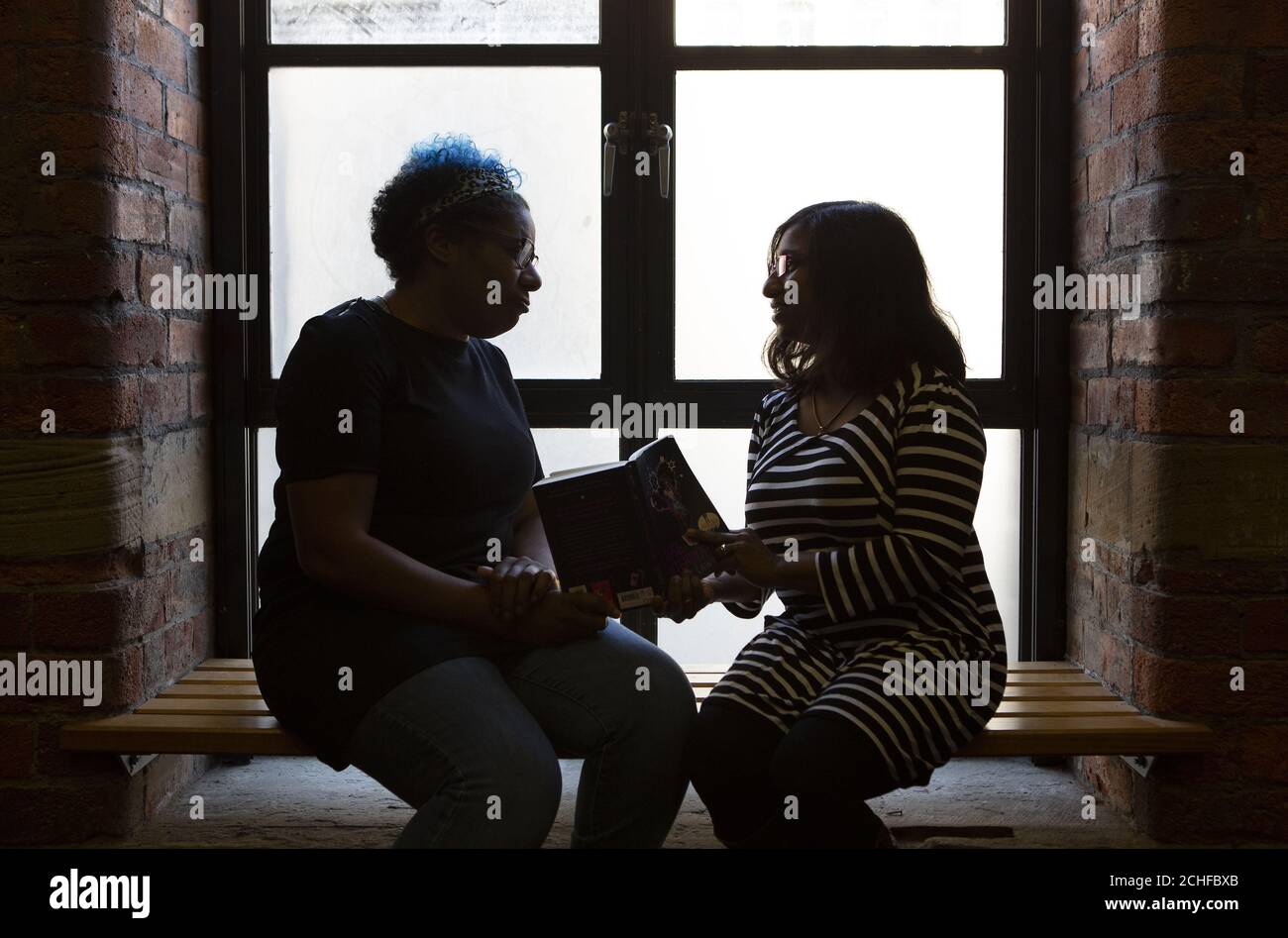 EDITORIAL USE ONLY Award-winning author Patrice Lawrence (left) sits ...