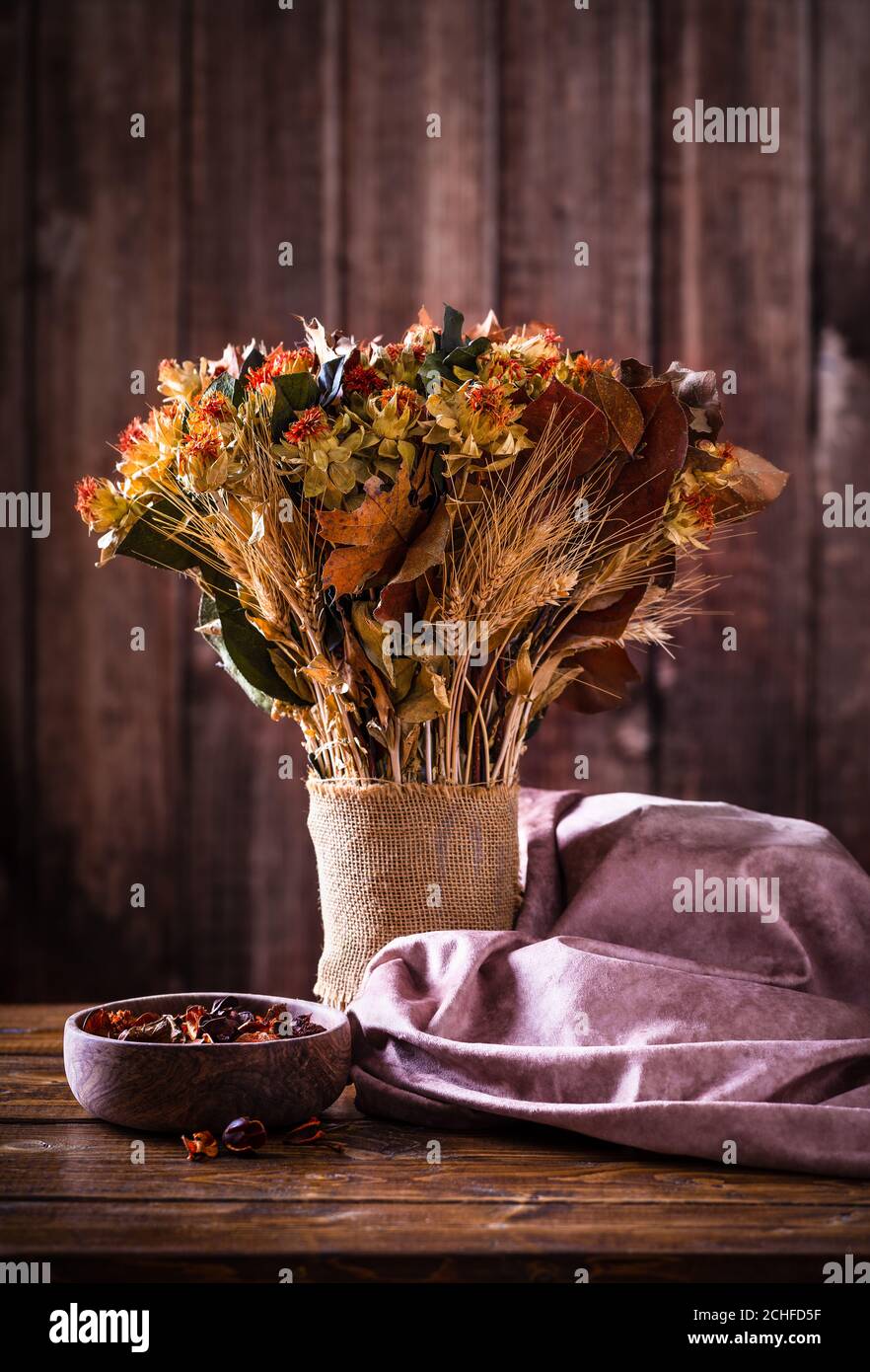 Bouquet of dried autumn flowers on a rustic wooden table and background ...