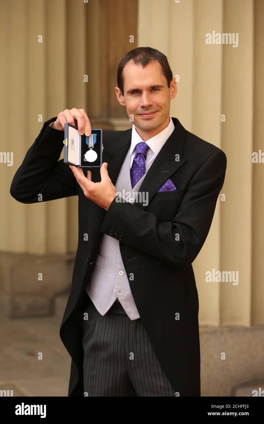 Mr Christopher Jewell holding The Queen's Gallantry Medal during an ...