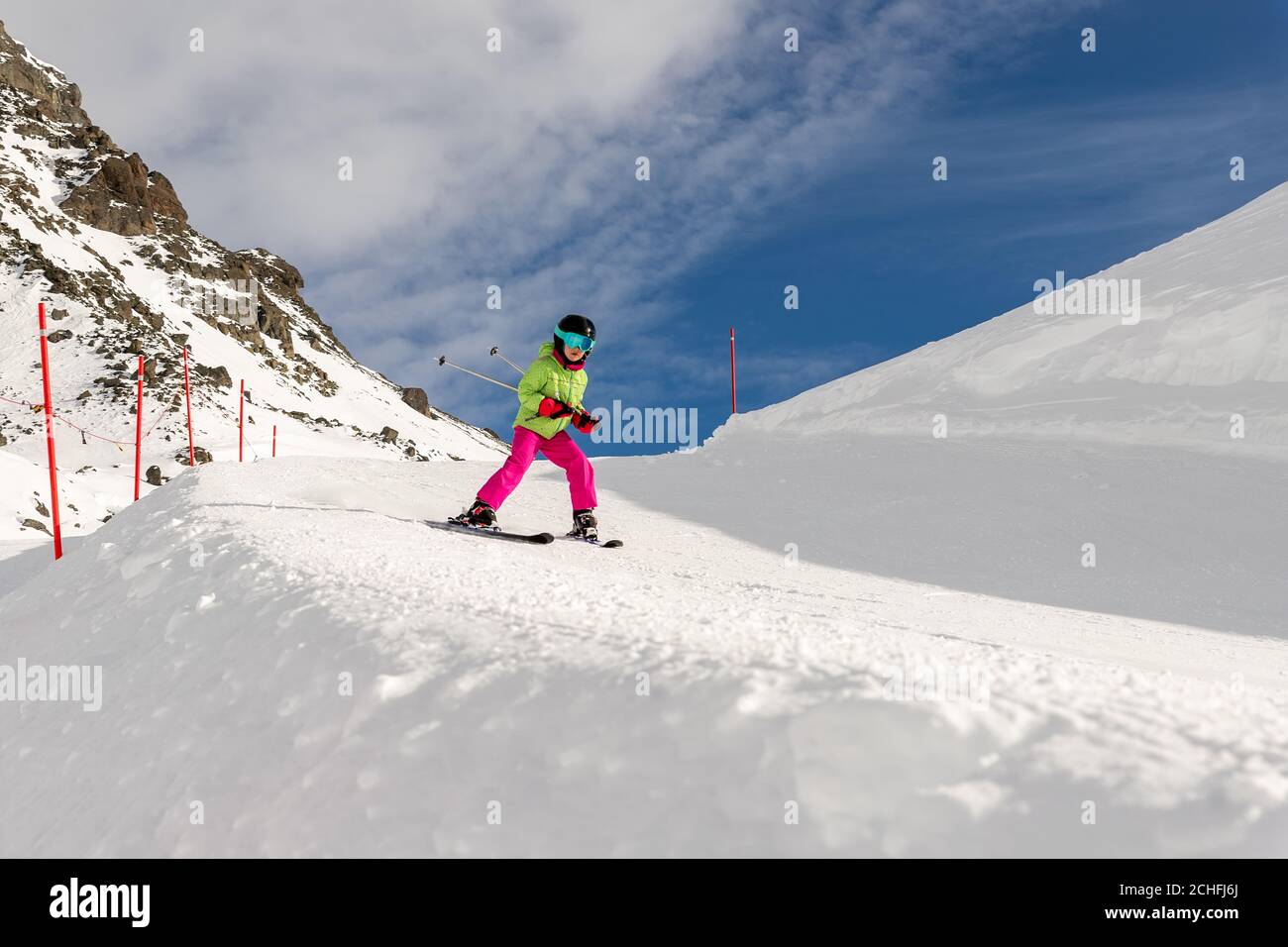 Active adorable preschooler caucasian smiling kid girlriding fast ski ...