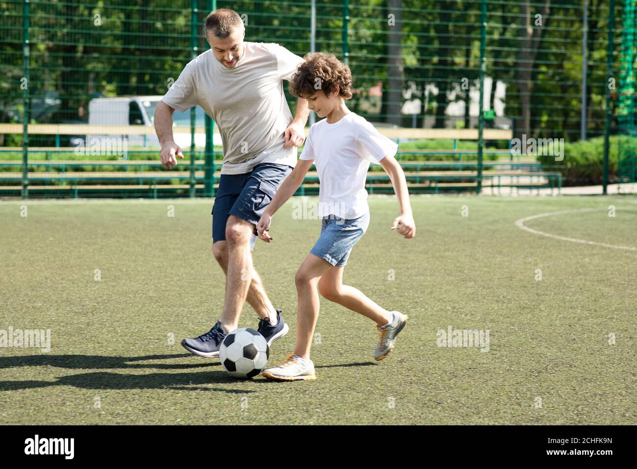 Boy playing soccer with dad hi-res stock photography and images - Alamy
