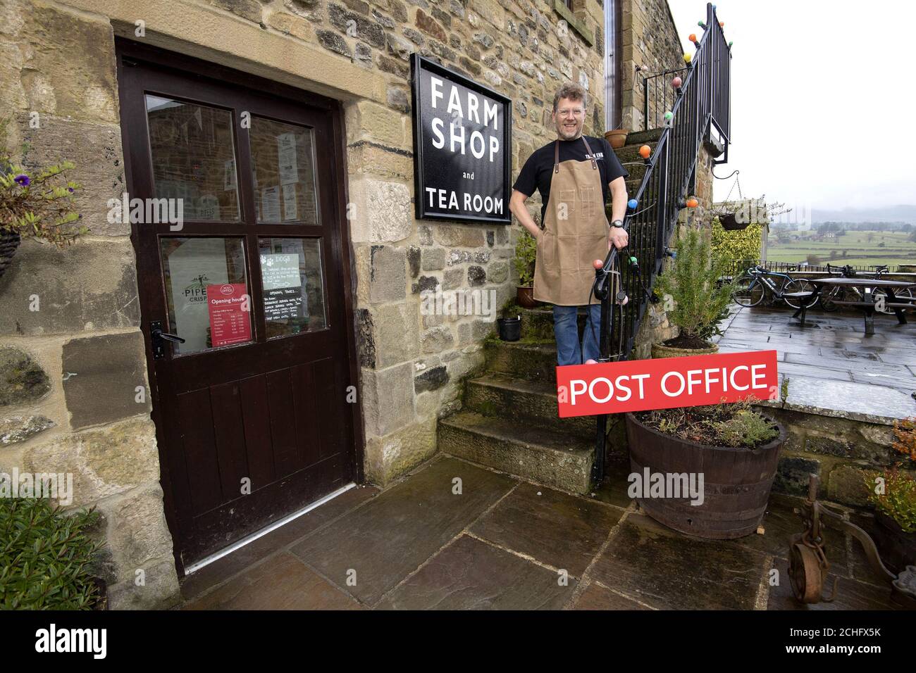 Postmaster Chris Wildman outside the newly opened Post Office at Town ...