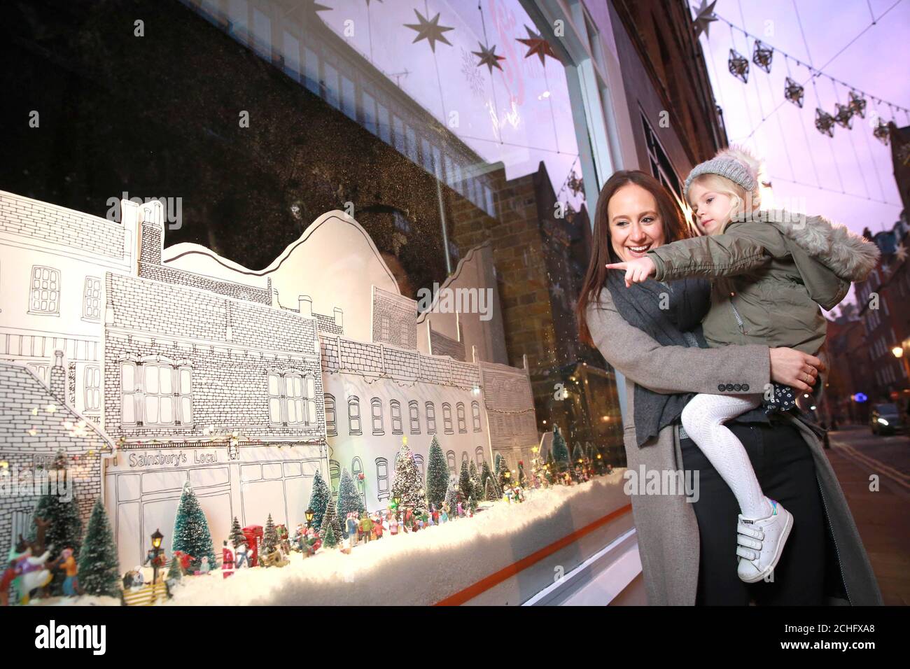 EDITORIAL USE ONLY Shoppers Lisa Fox and Sophia, age 3, visit the ...