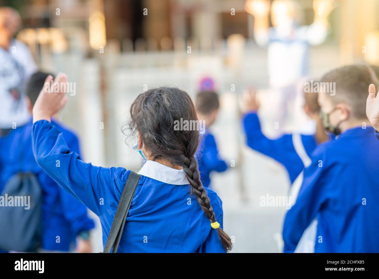 Back view of primary school classmates on the first day of lessons ...