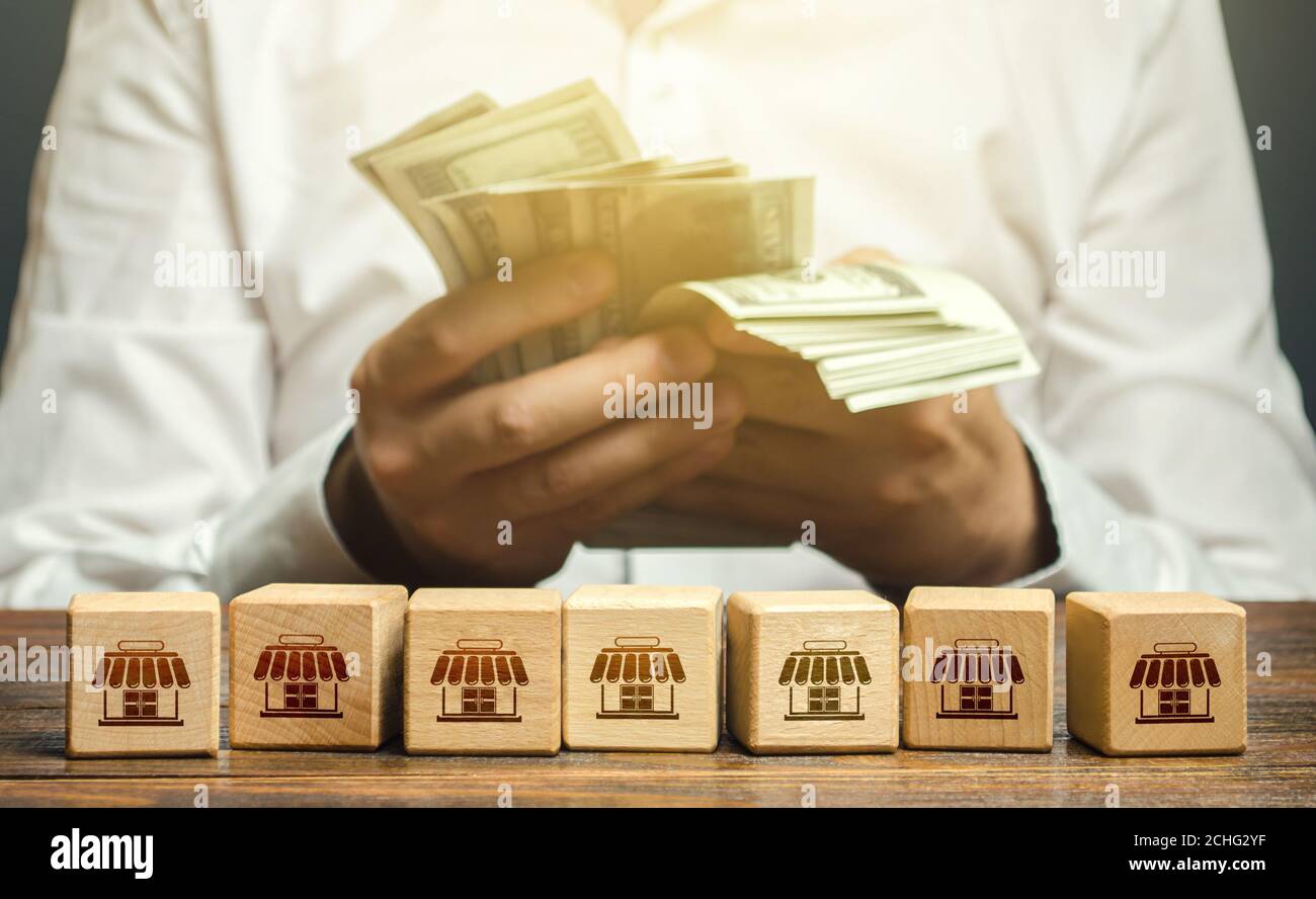 Blocks symbolizing business network and businessman counting money ...