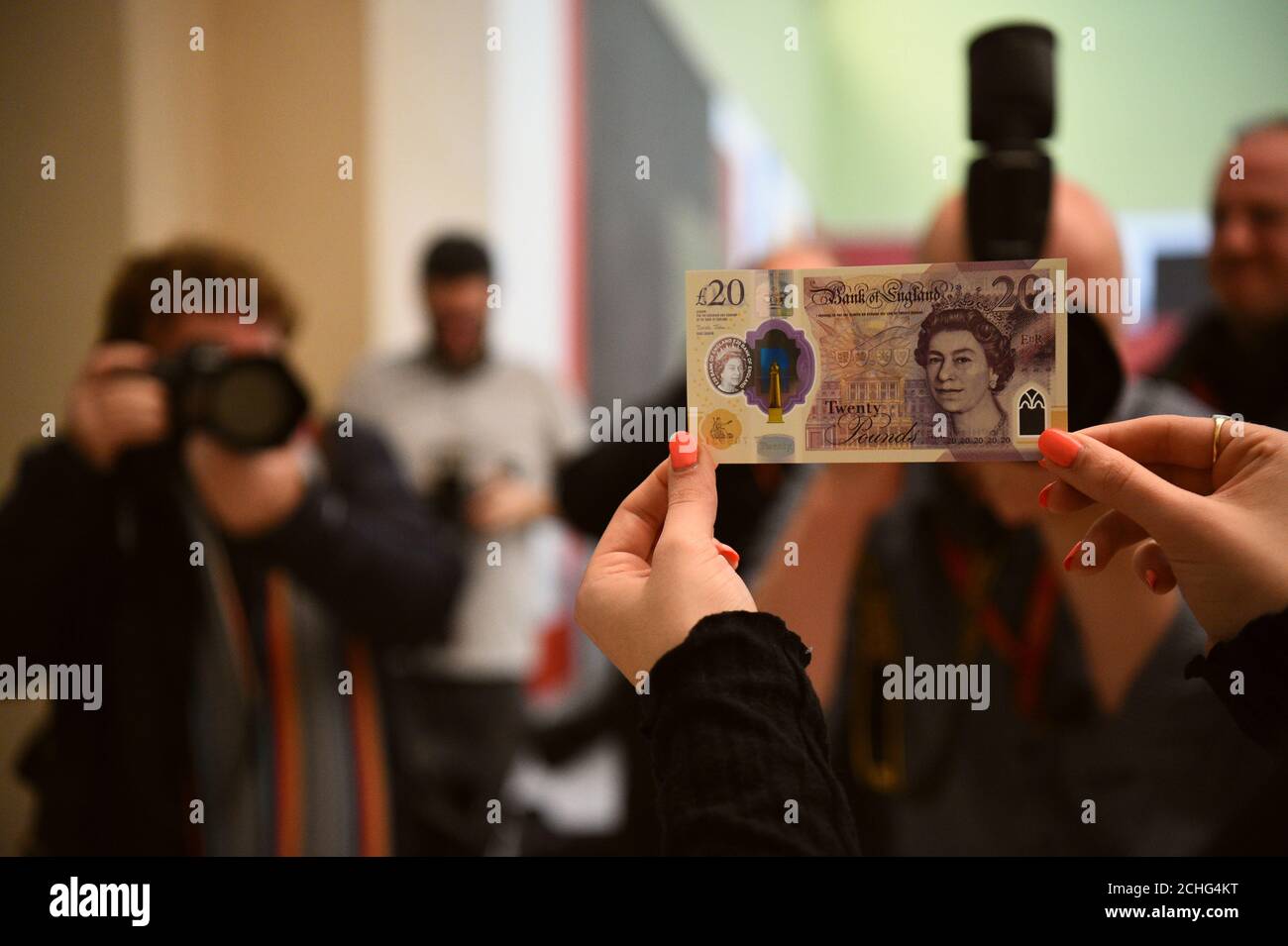 Photographers take pictures of the new £20 note which features artist ...