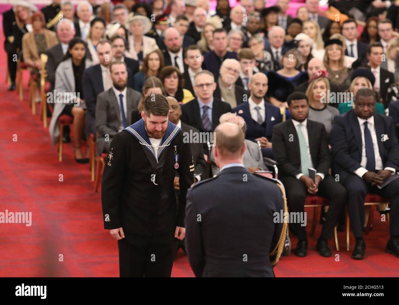 Leading Seaman David Groves, Royal Navy, is decorated with the Queen's ...