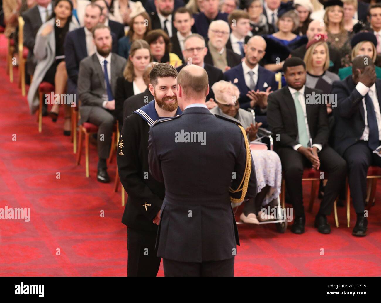 Leading Seaman David Groves, Royal Navy, is decorated with the Queen's ...