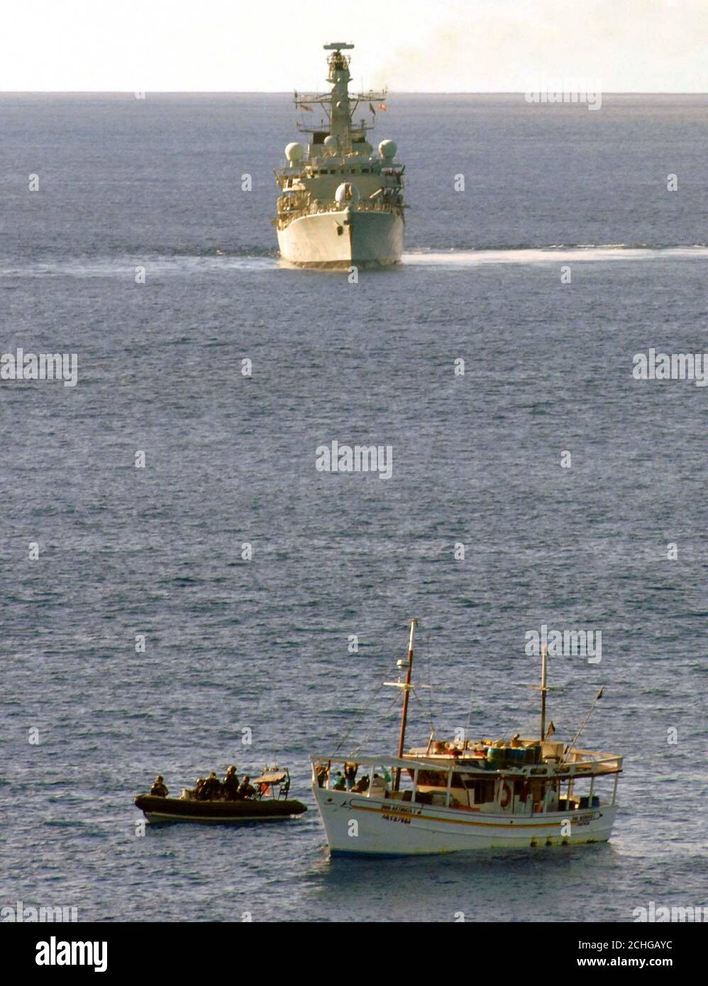HMS Portland and its seaboat (foreground left) challenge drugs runners ...