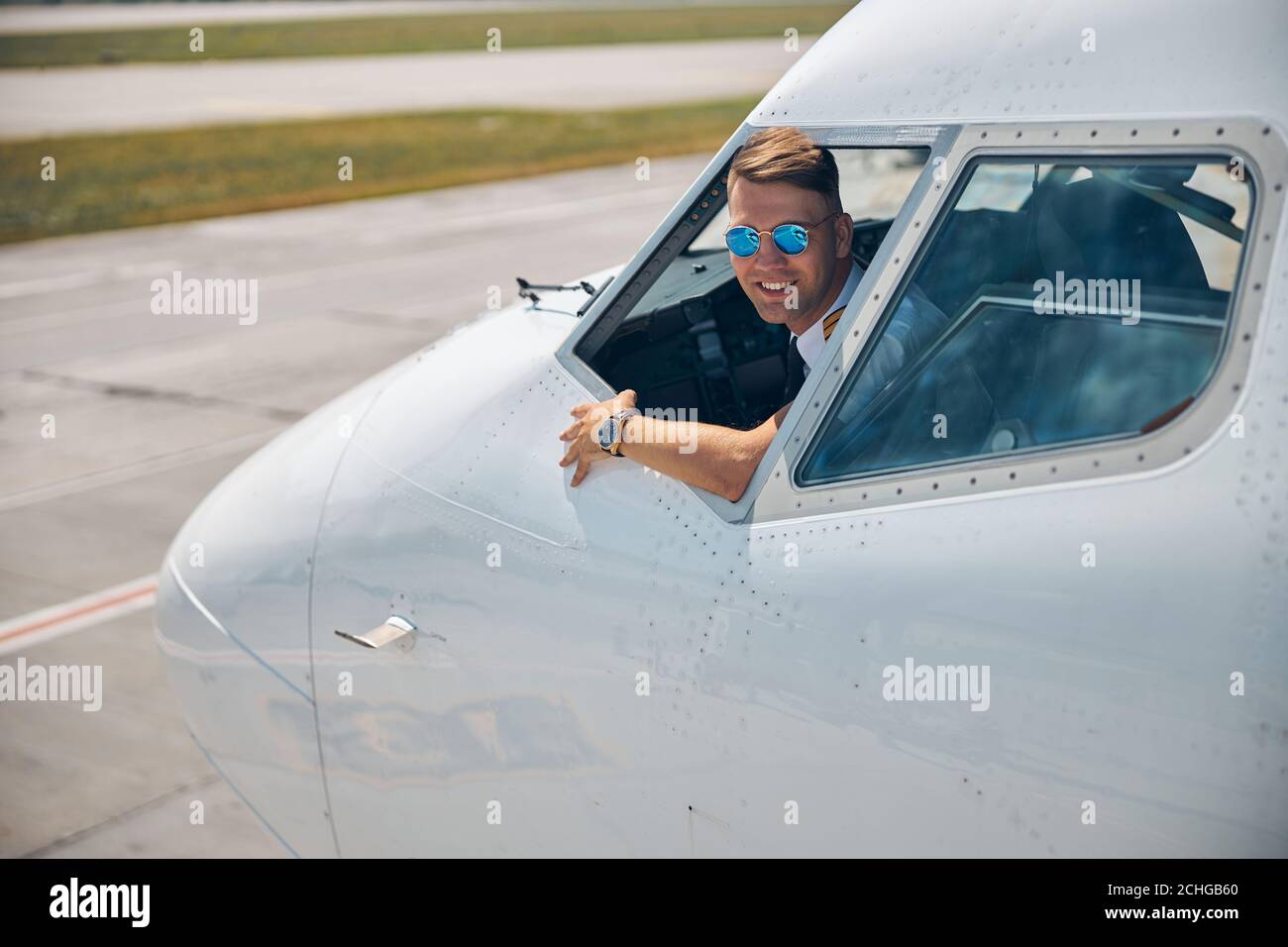 Handsome young pilot sitting inside plane cockpit Stock Photo - Alamy