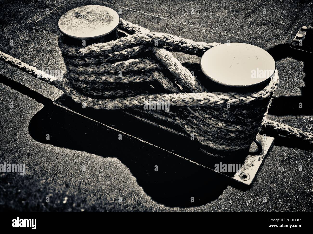Grayscale shot of the strong ropes knotted on the mooring Stock Photo ...
