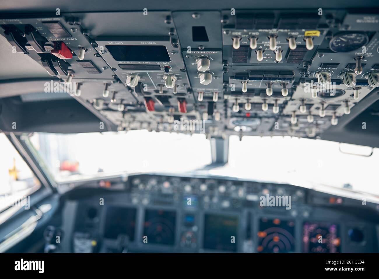 Overhead panel of airplane flight deck with switches and knobs Stock ...