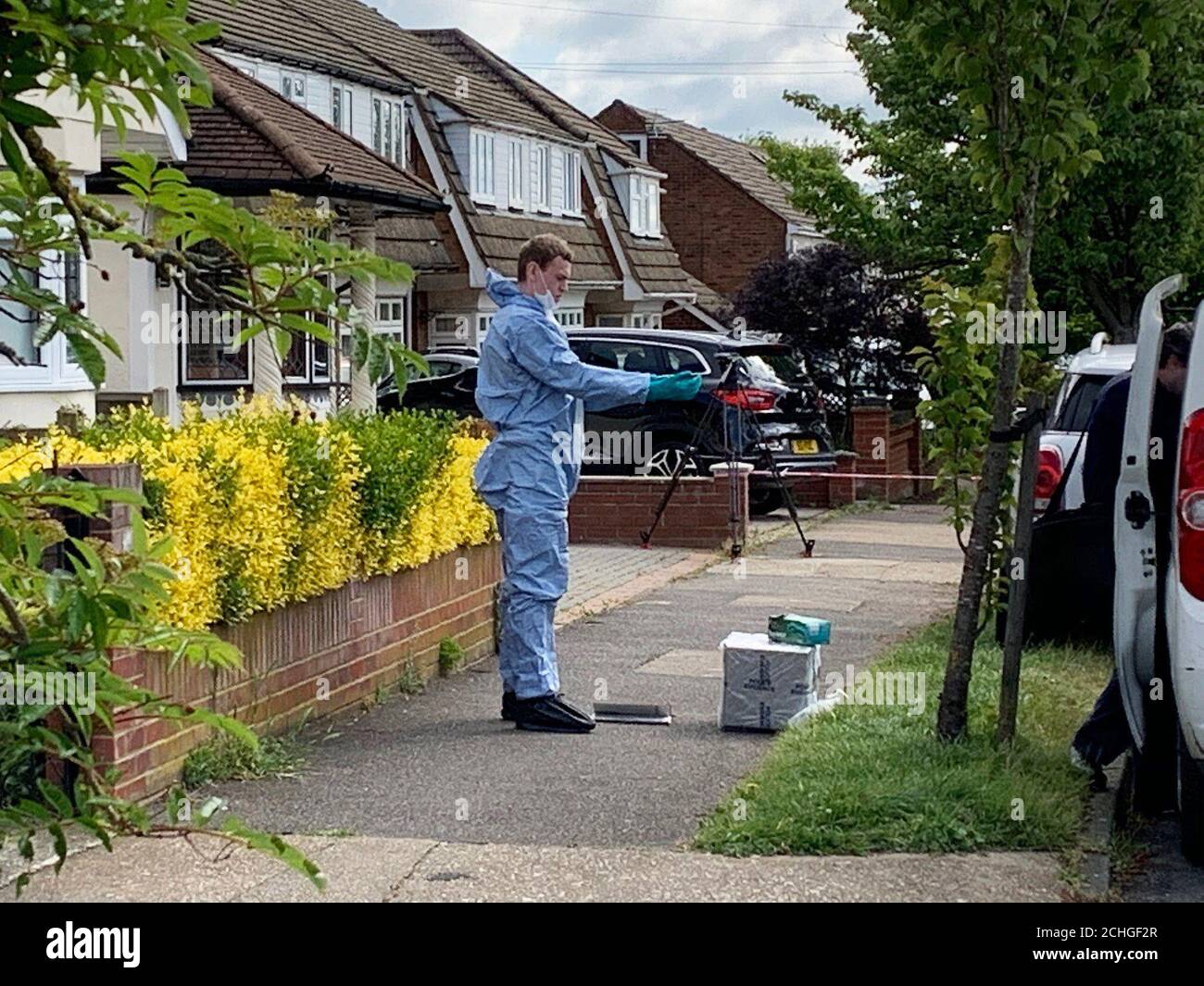 A police forensic officer at the scene in Kerry Drive, Upminster, East ...