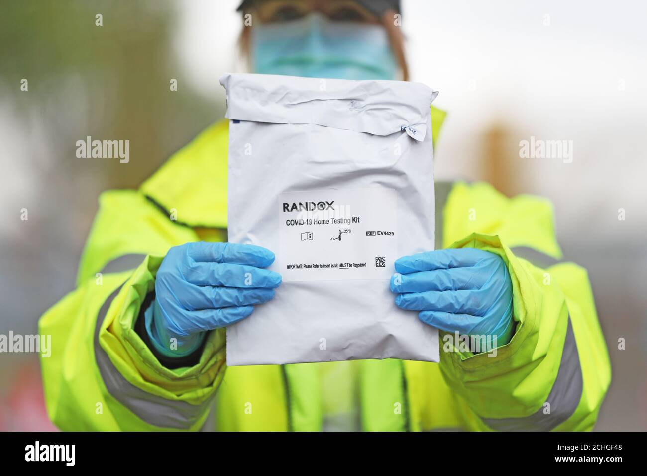 A member of the testing staff holds a Randox laboratories Covid-19 self ...
