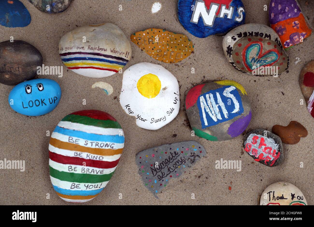 Painted pebbles showing support for the NHS and keyworkers, and ...
