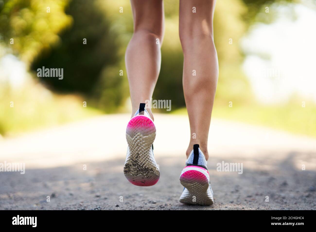 Down section of female runner jogging in the countryside Stock Photo ...