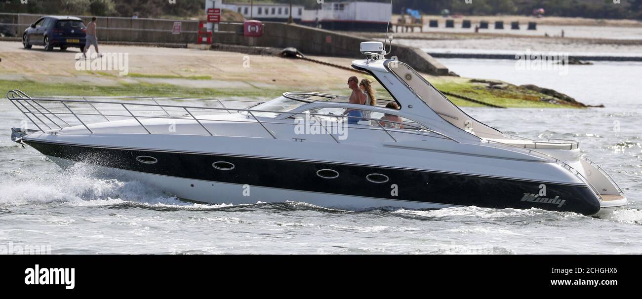 People in a boat enjoying the hot weather off Sandbanks near Poole ...