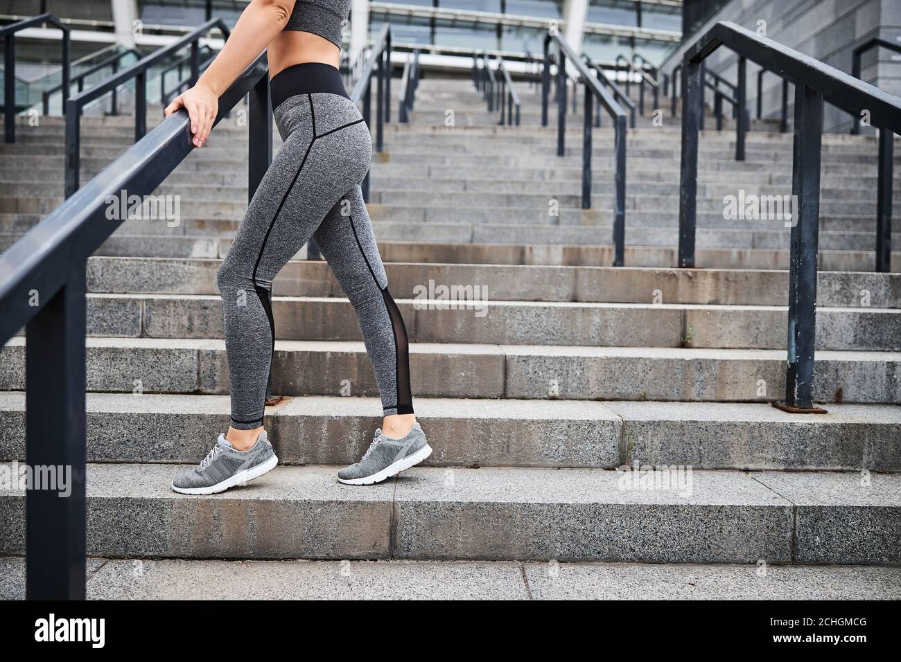 Athletic woman in outfit on steps in city centre Stock Photo - Alamy