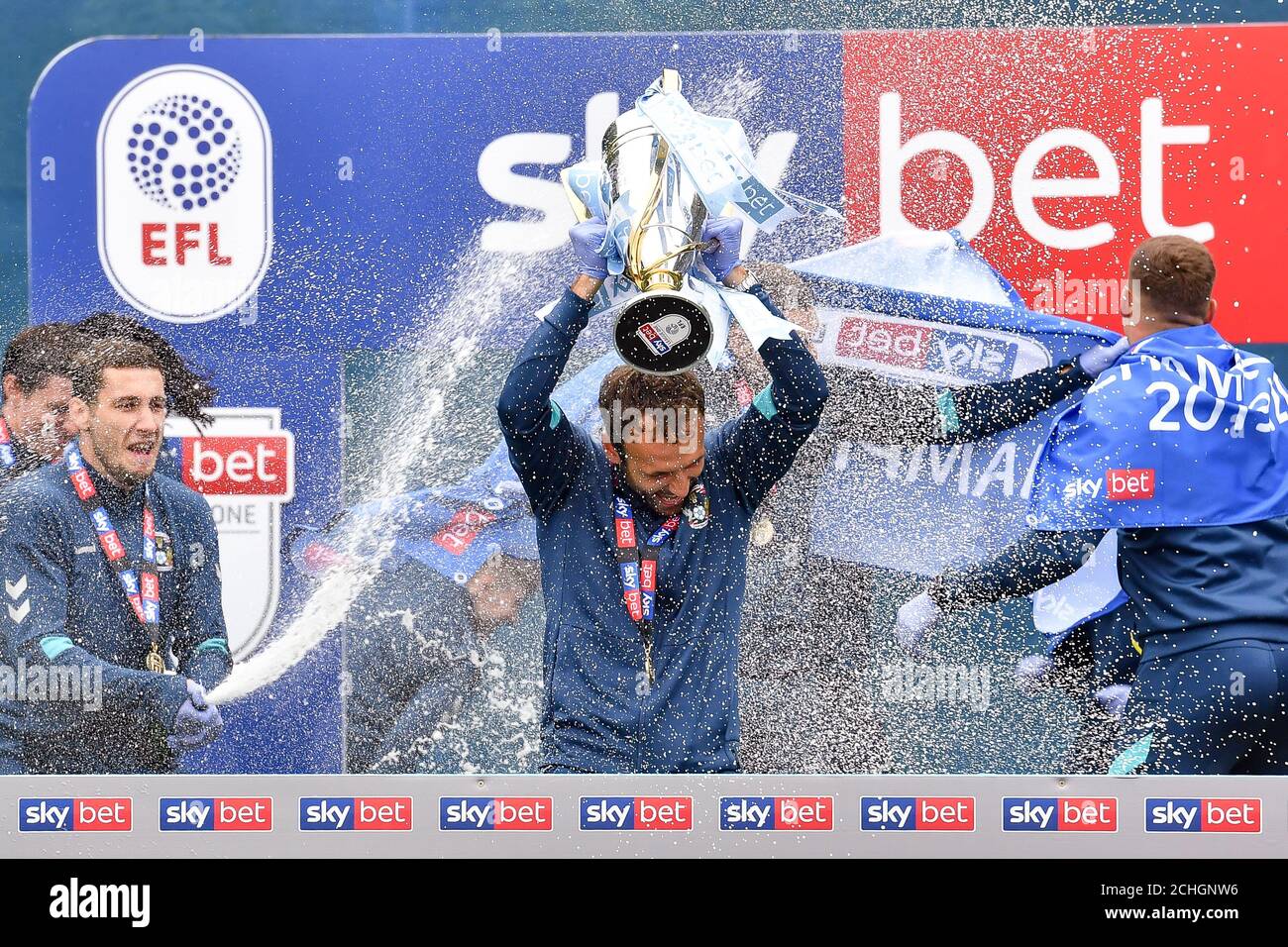 Captain Liam Kelly lifts the trophy as the Coventry City squad ...