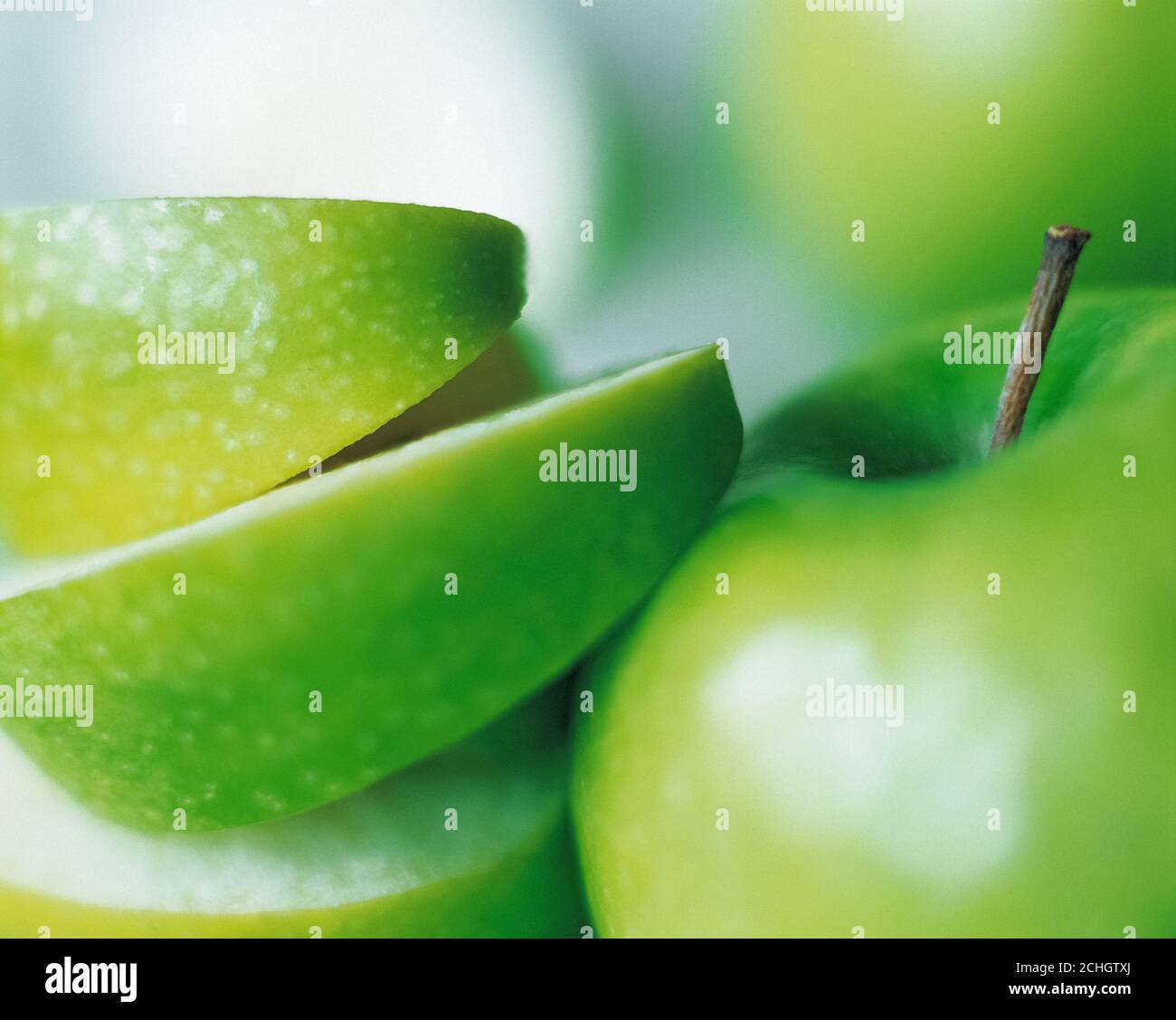 Juicy green apple slices with whole fruit close-up, organic apples ...