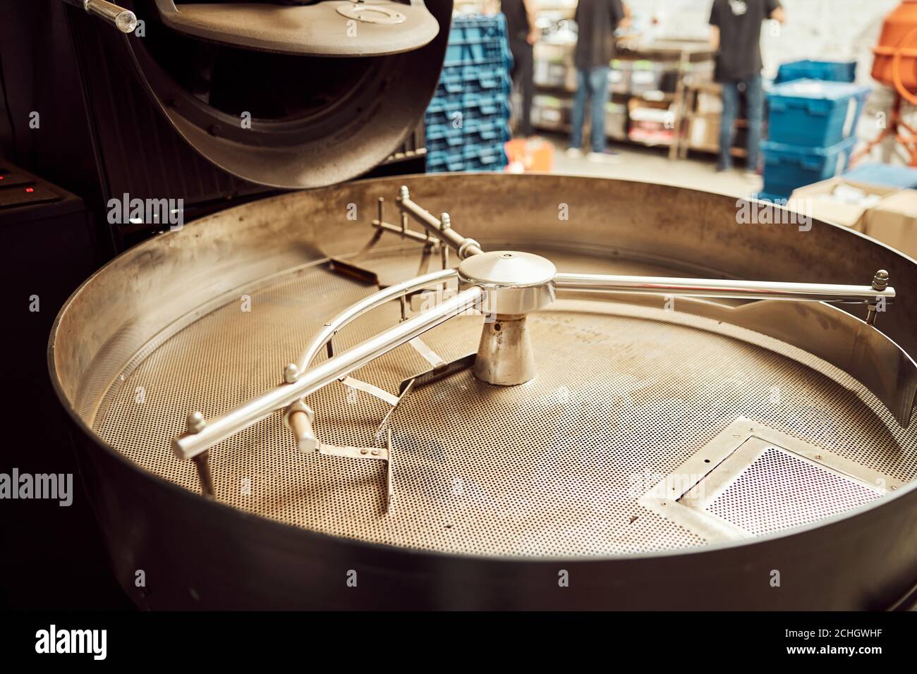 Coffee roasting machine with workers on background Stock Photo - Alamy