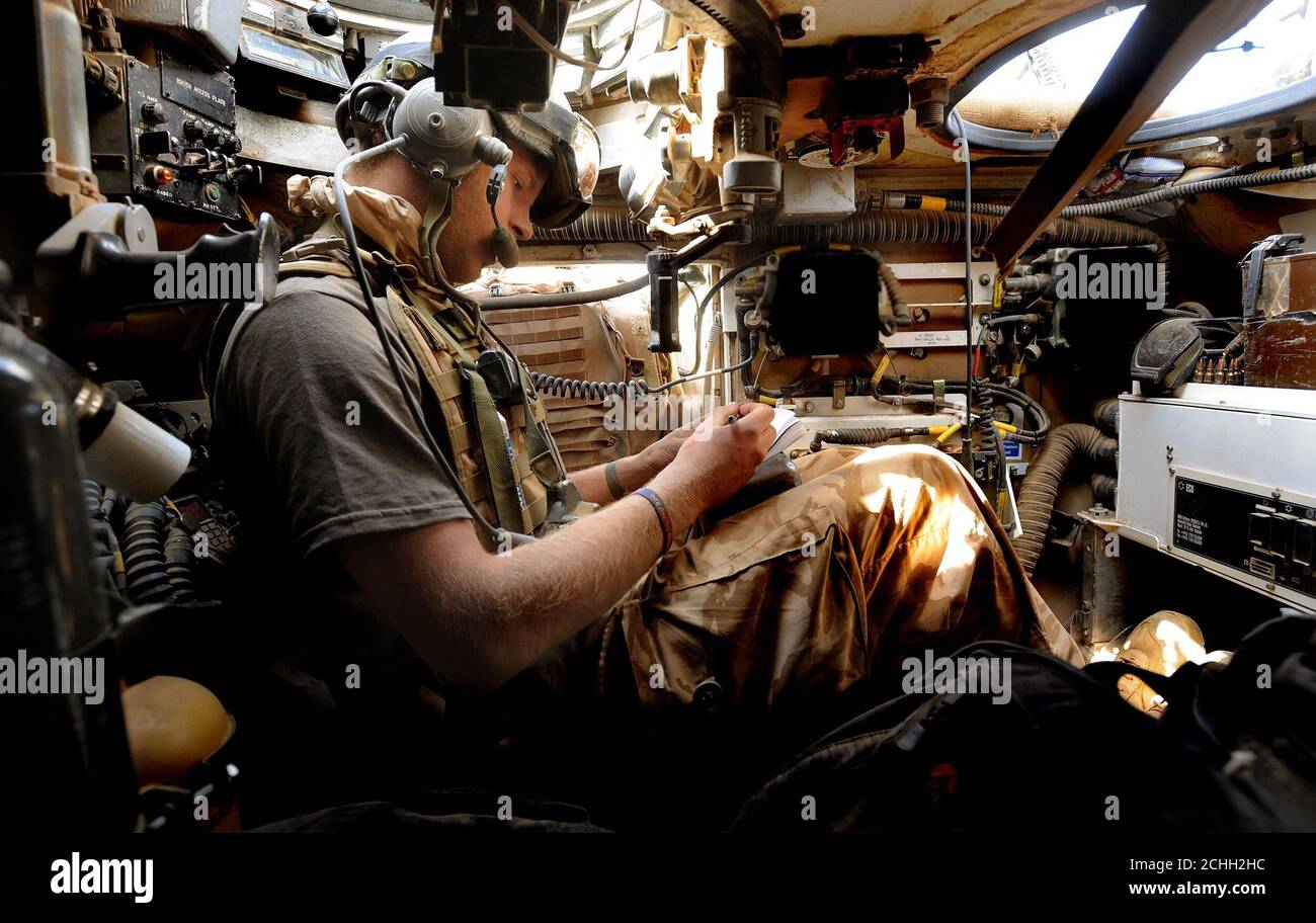 Prince Harry sits below the turret of his spartan armoured vehicle as ...