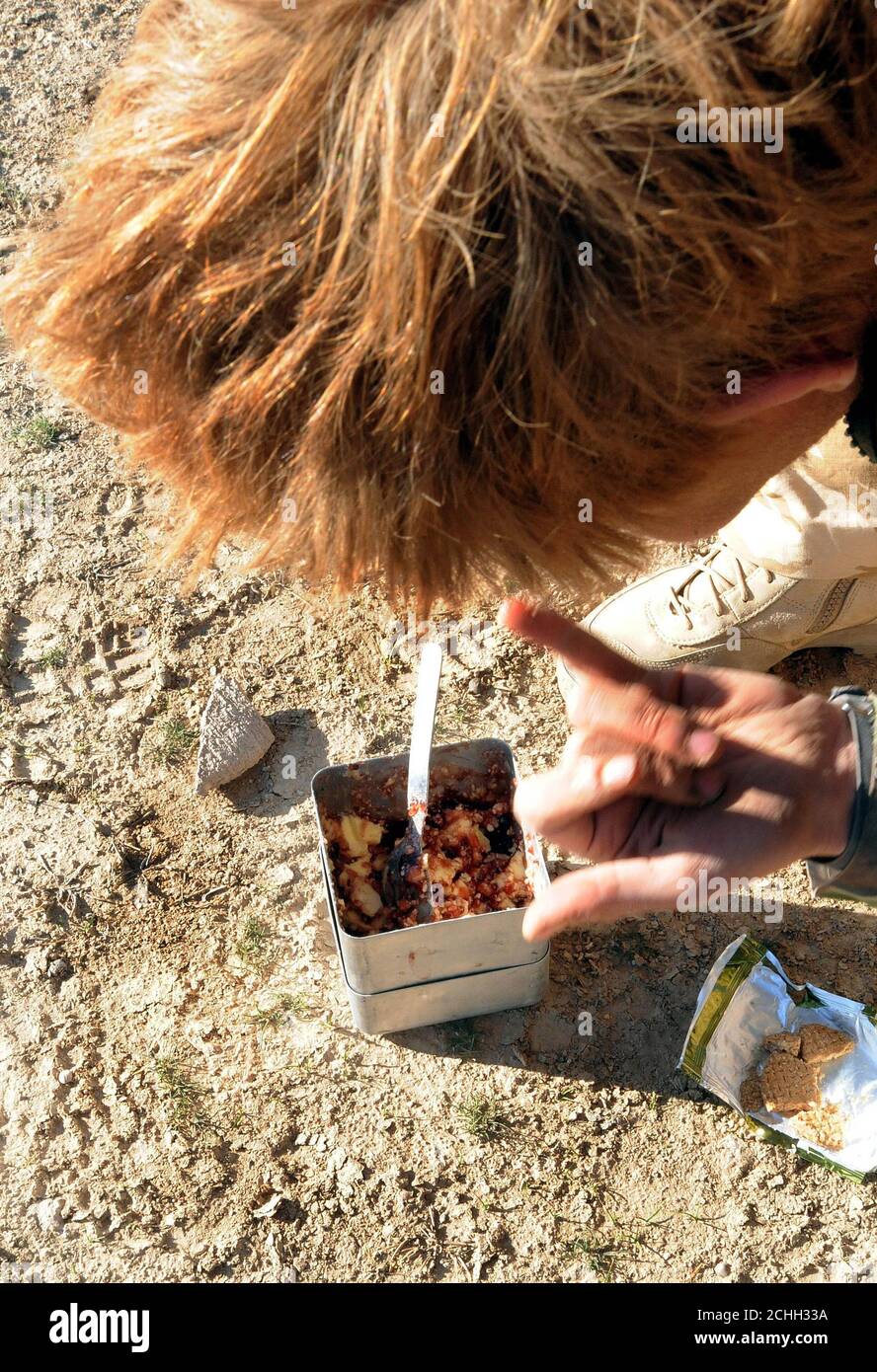 Prince Harry licks his fingers as he eats a breakfast of biscuits mixed ...