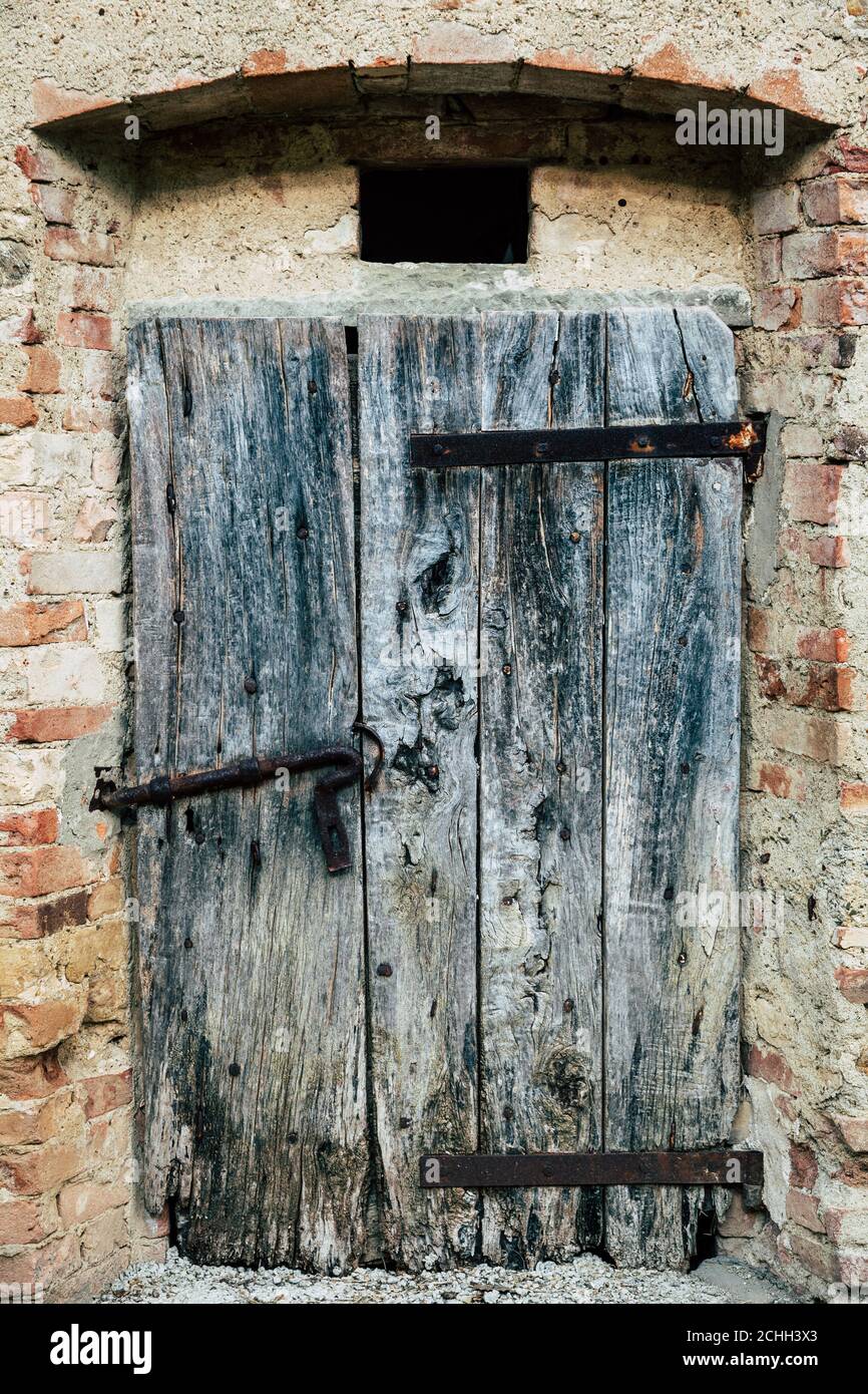 An old weathered door to wine cellar at a winery in Tuscany, Italy ...