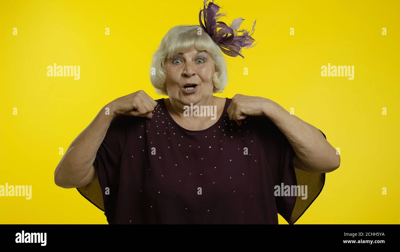 Choose me. Happy proud egoistic beautiful senior old woman pointing ...