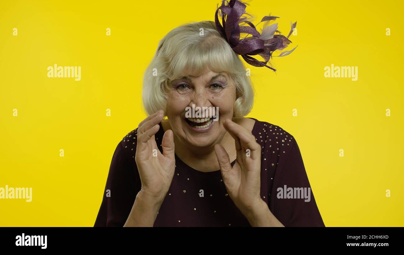 Happy joyful senior old woman laughing out loud after hearing ...