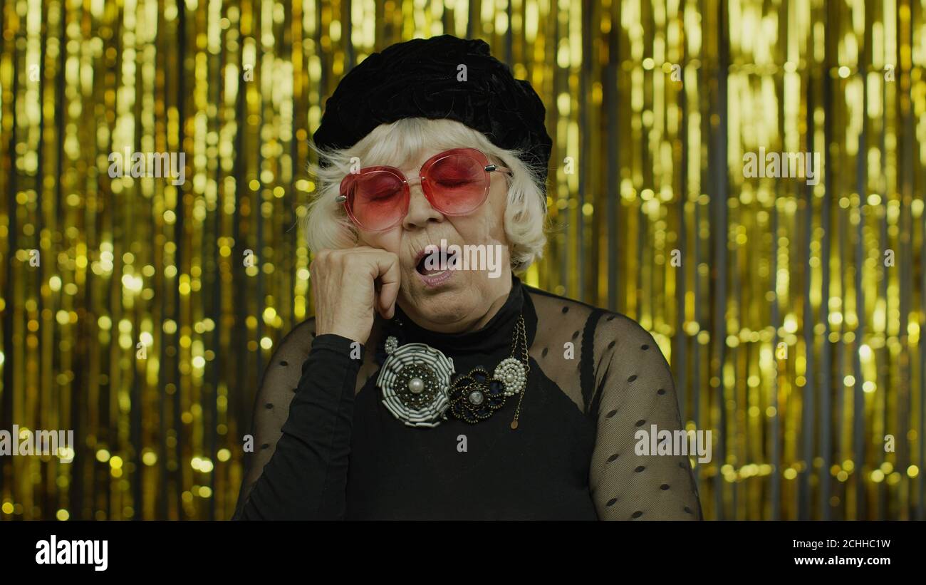 Bored unhappy senior old woman leaning on hand after listening boring ...