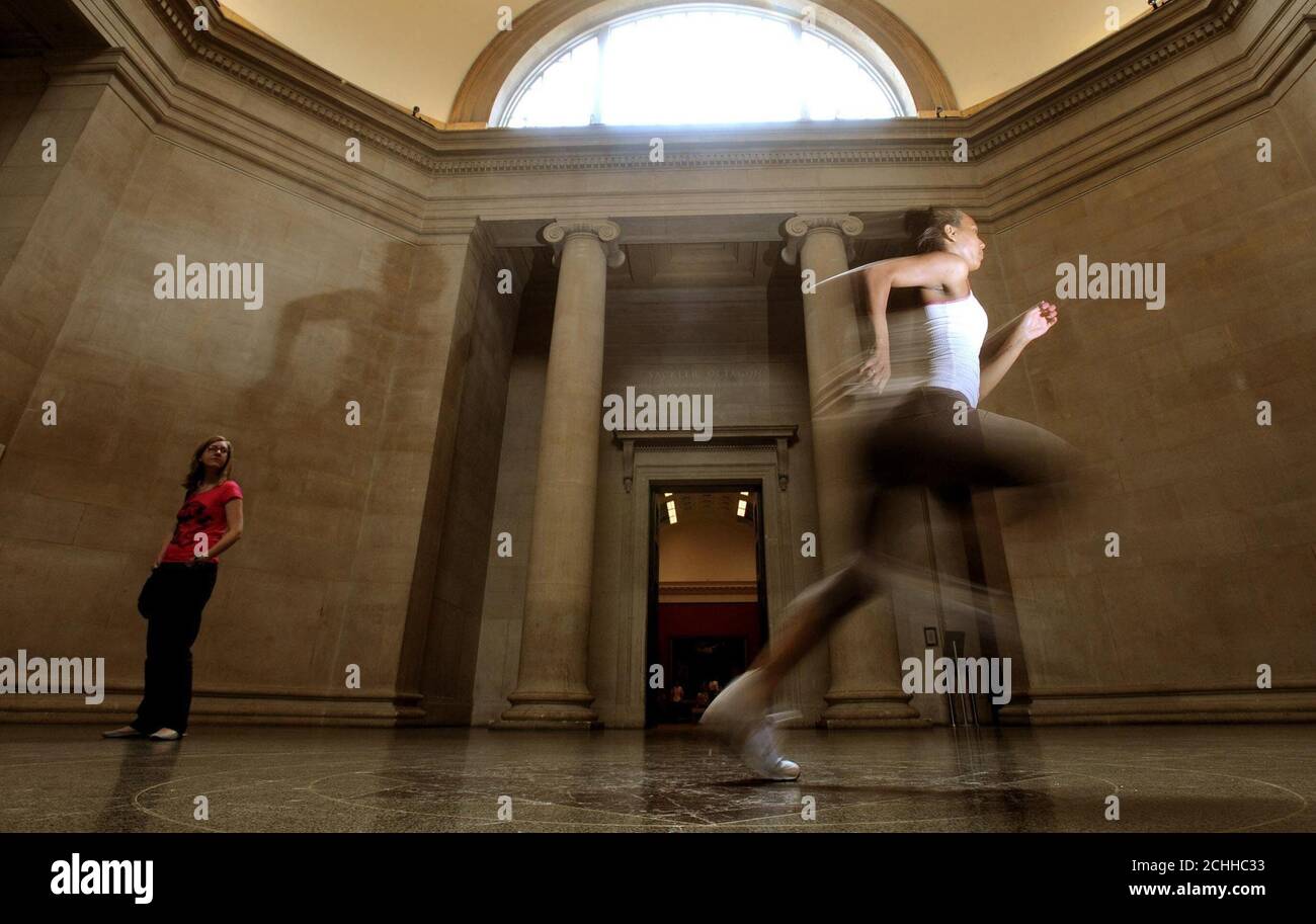 A runner sprints through the Tate Britain art gallery in central London ...