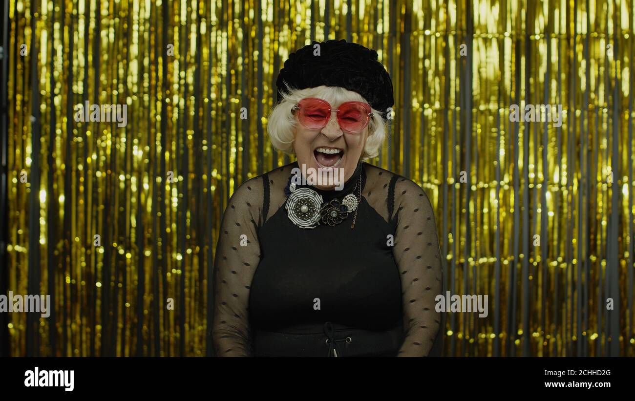 Happy joyful senior old woman laughing out loud after hearing ...