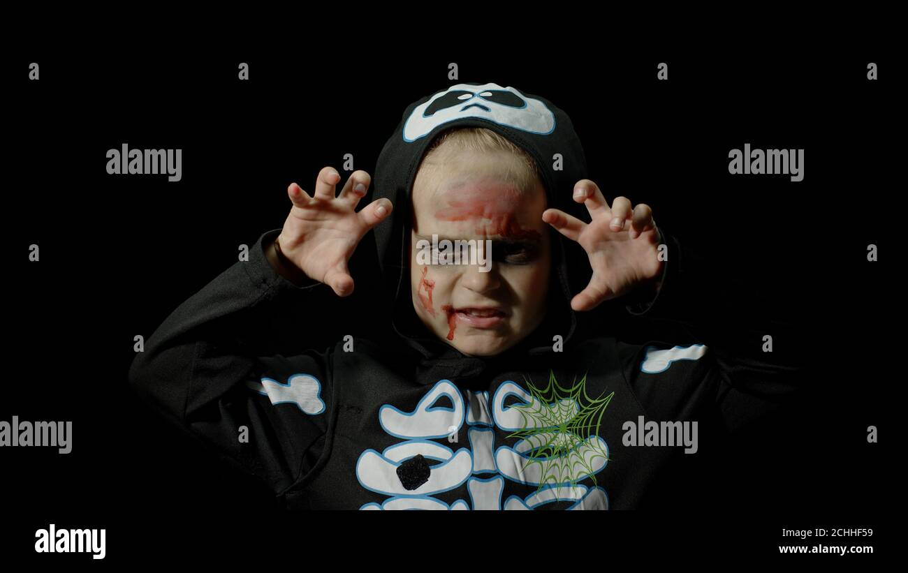 Halloween, angry child girl with blood makeup on her face. Kid dressed ...