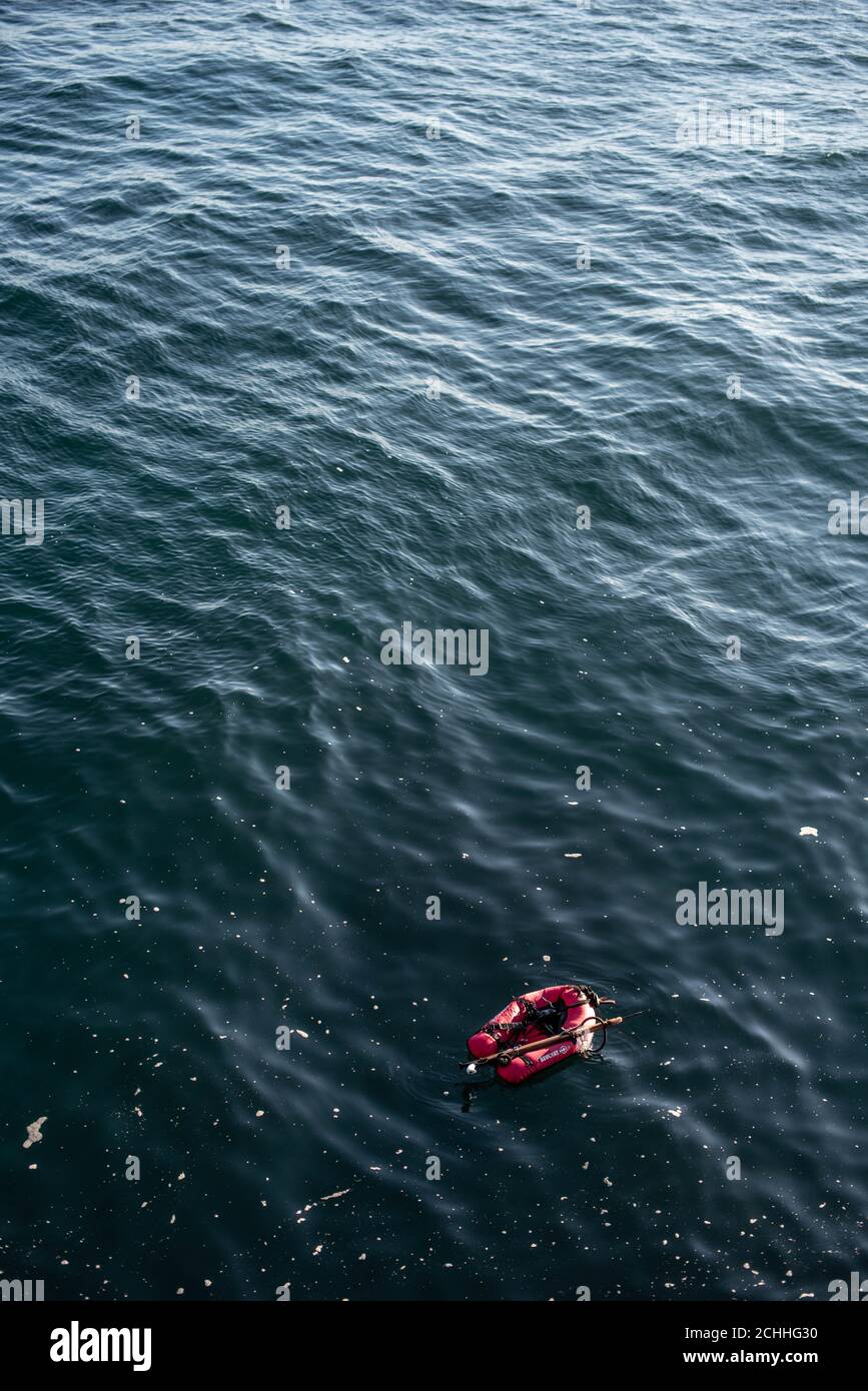 Vertical shot of a sea with a red raft Stock Photo - Alamy