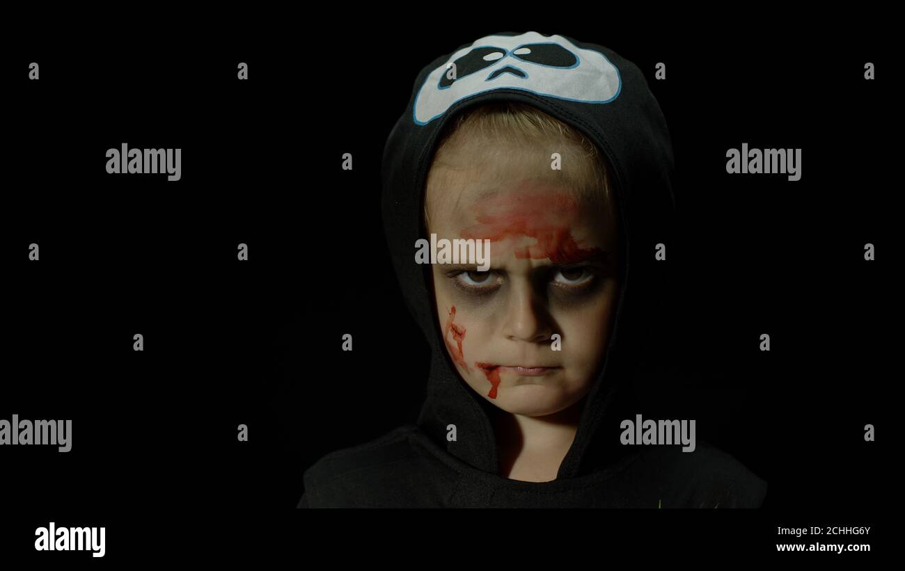 Halloween. Portrait of angry child girl with blood makeup on her face ...