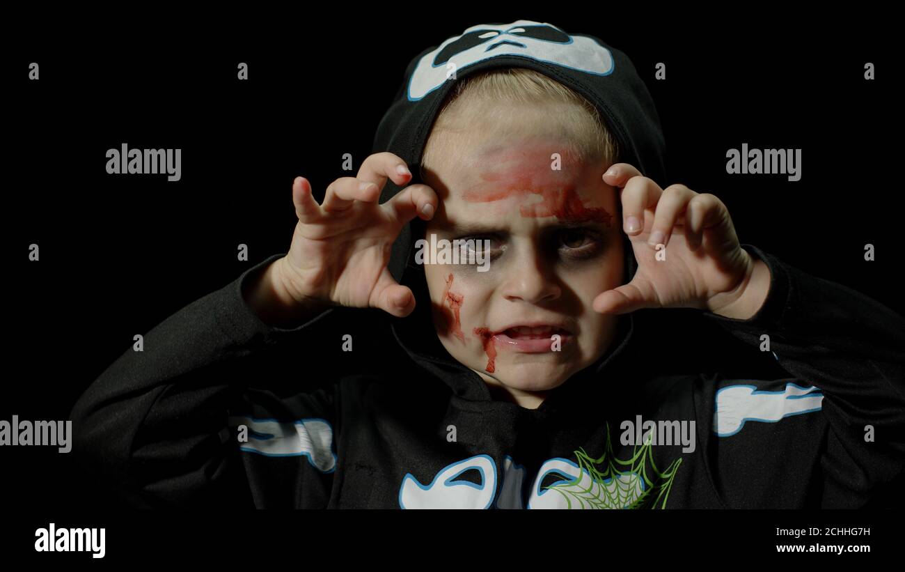Halloween, angry child girl with blood makeup on her face. Kid dressed ...