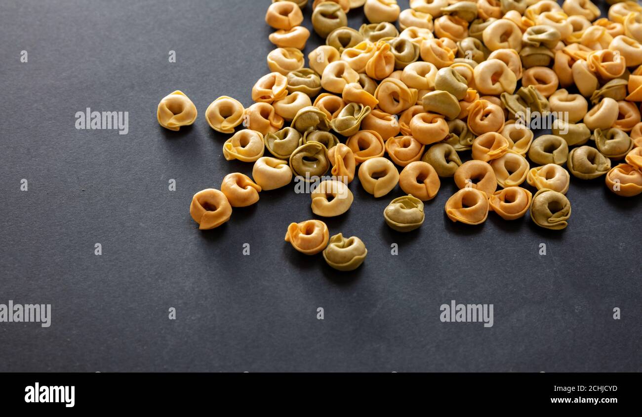 Pasta cooking concept. Fresh homemade tortellini on black stone ...