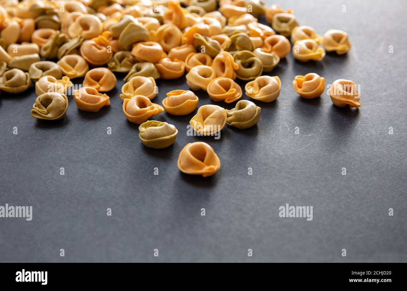 Pasta cooking concept. Fresh homemade tortellini on black stone ...